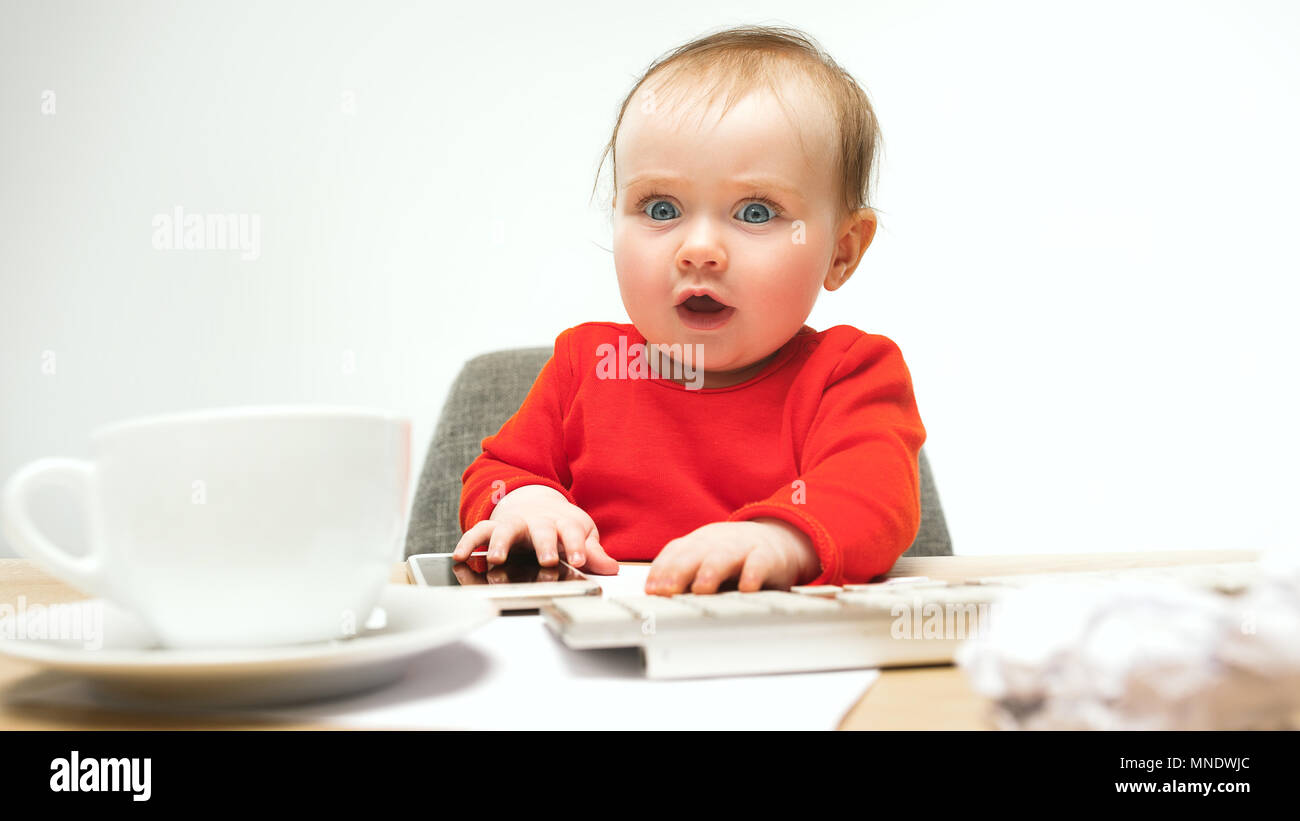 Happy child baby girl toddler sitting with keyboard of computer ...