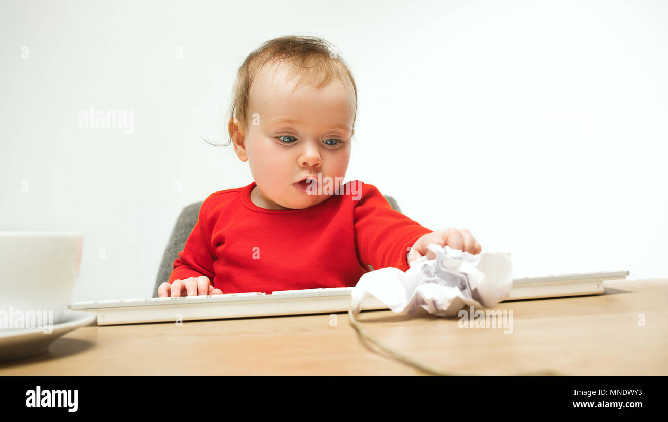 Happy child baby girl toddler sitting with keyboard of computer ...