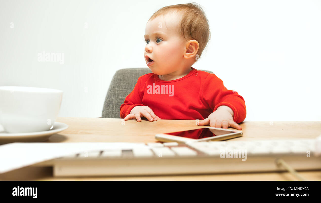 Happy child baby girl toddler sitting with keyboard of computer ...