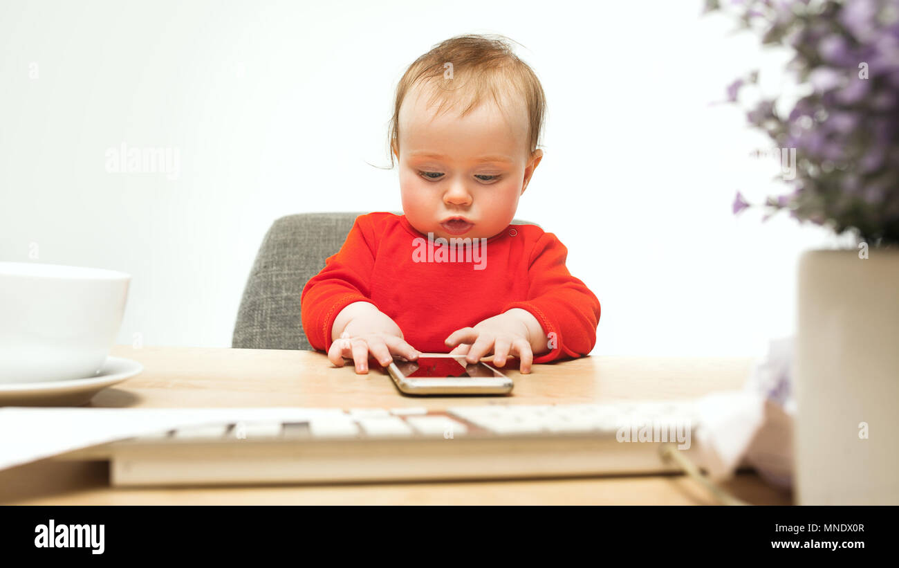 Happy child baby girl toddler sitting with keyboard of computer ...
