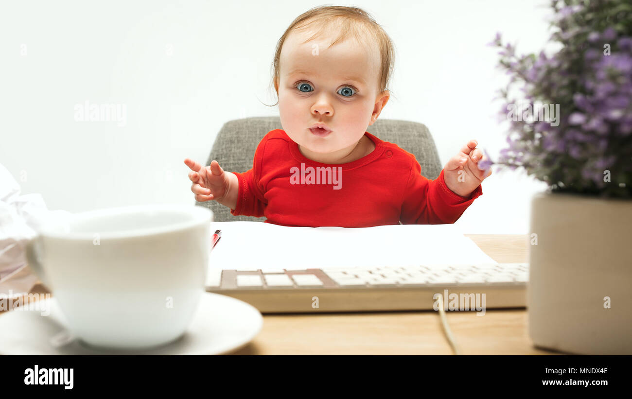 Happy child baby girl toddler sitting with keyboard of computer ...
