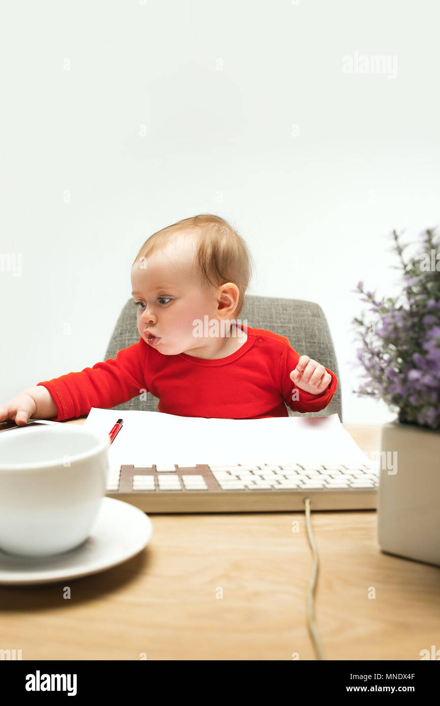 Happy child baby girl toddler sitting with keyboard of computer ...