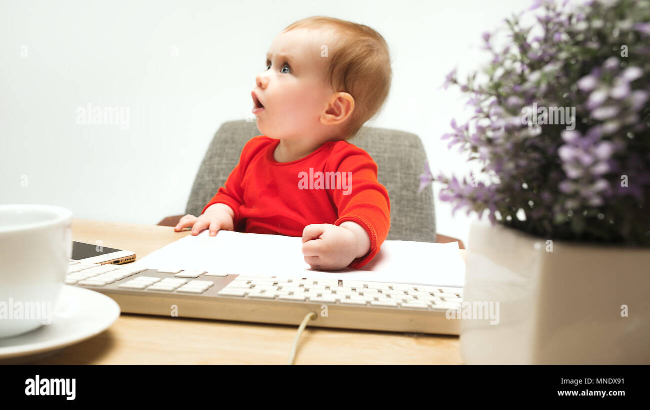 Happy child baby girl toddler sitting with keyboard of computer ...