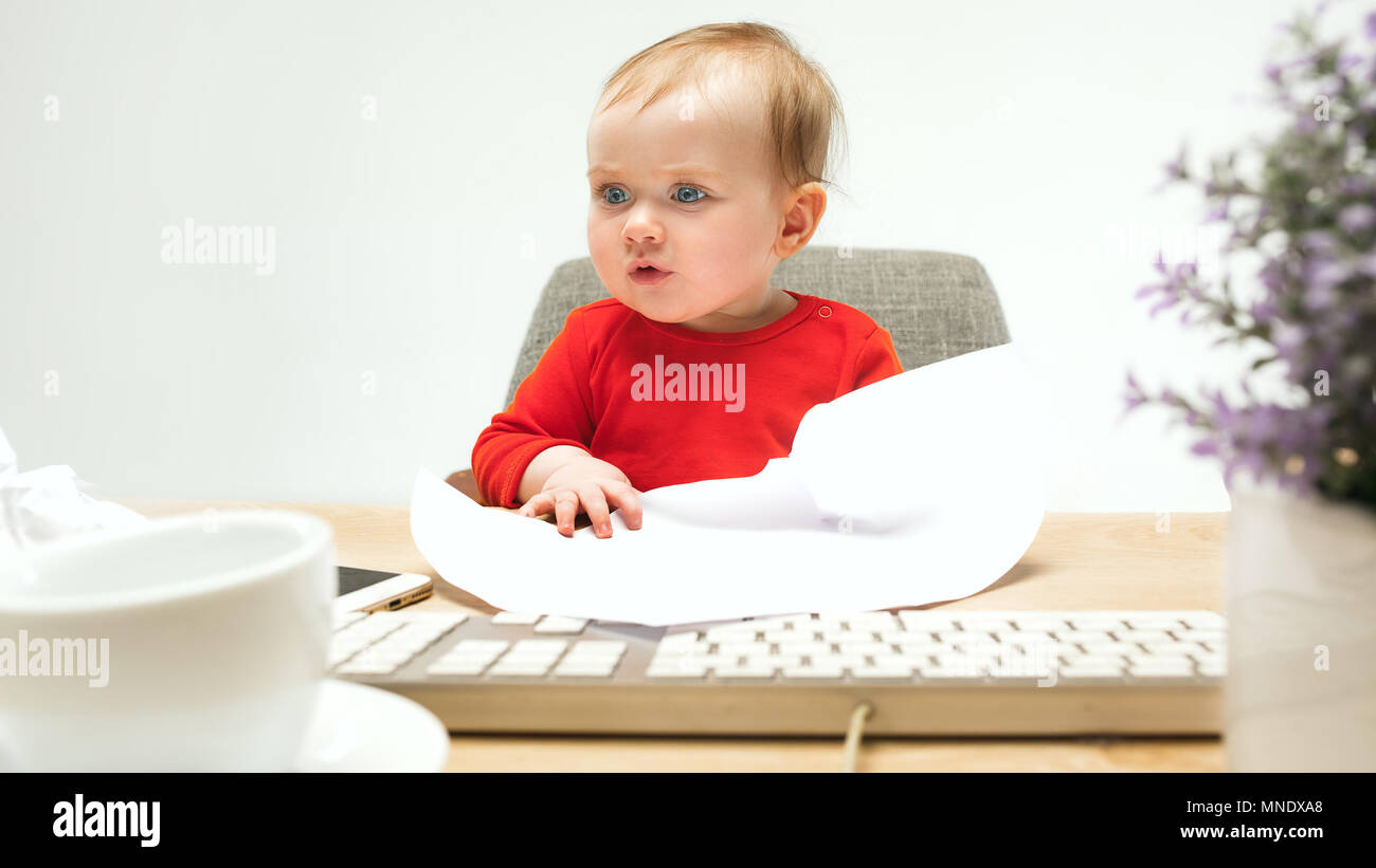 Happy child baby girl toddler sitting with keyboard of computer ...