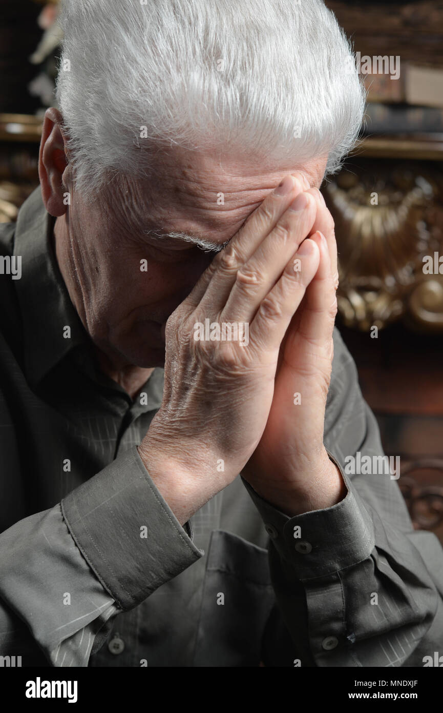 Portrait of Sad senior man praying Stock Photo - Alamy