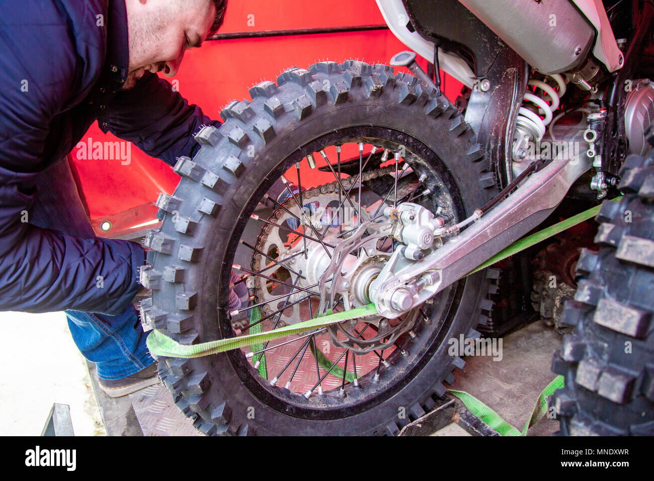 mechanic fixing motorcycle wheel Stock Photo - Alamy