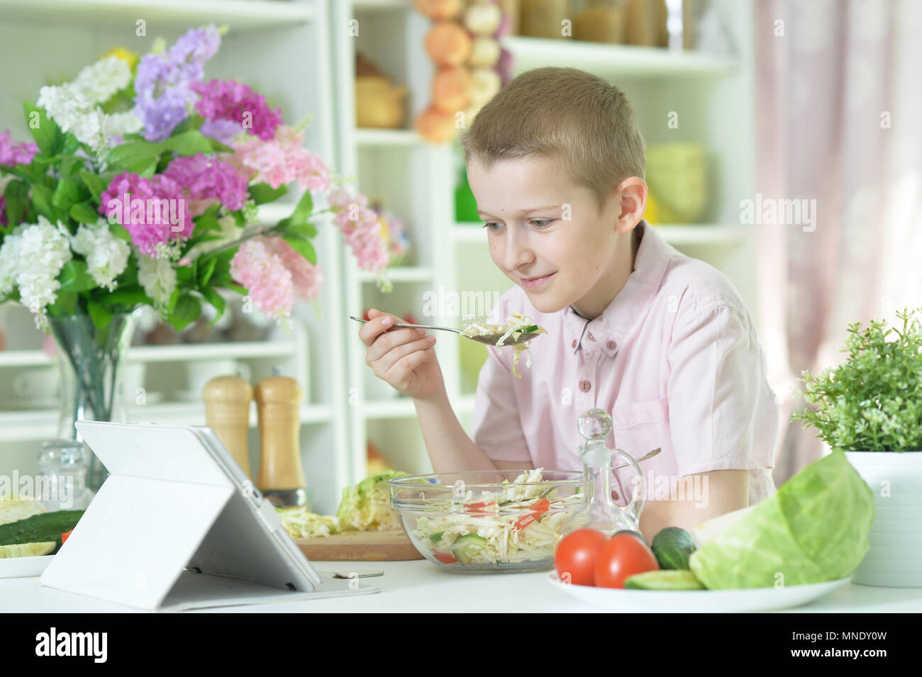 Cute little boy making dinner Stock Photo - Alamy