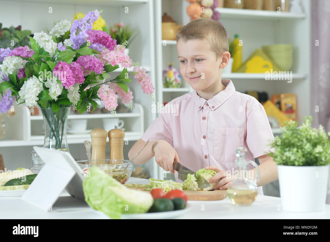 Cute little boy making dinner Stock Photo - Alamy