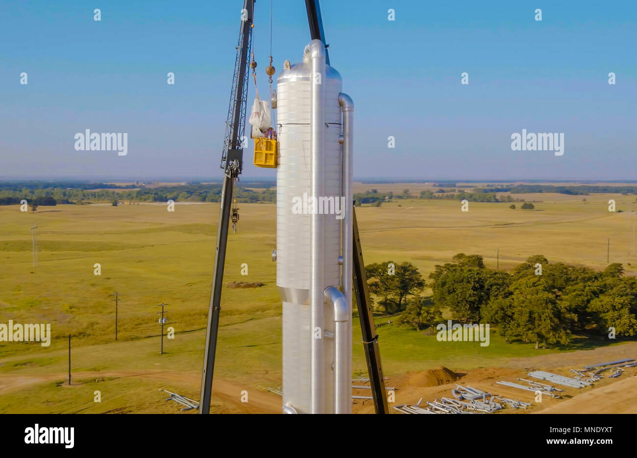 Installation of the distillation column with a lift crane. Construction ...