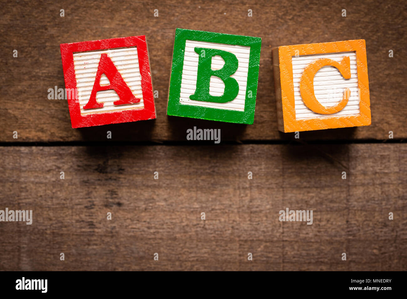 Colorful wooden letter blocks making the on brown wood background Stock ...