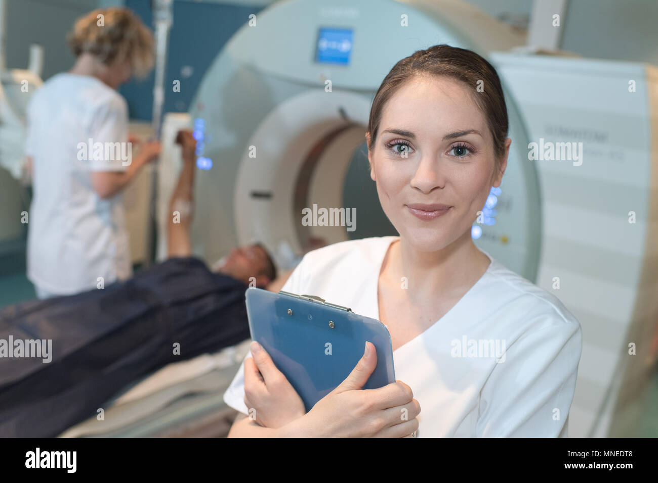 female radiologist with colleagues standing by mri machine Stock Photo ...