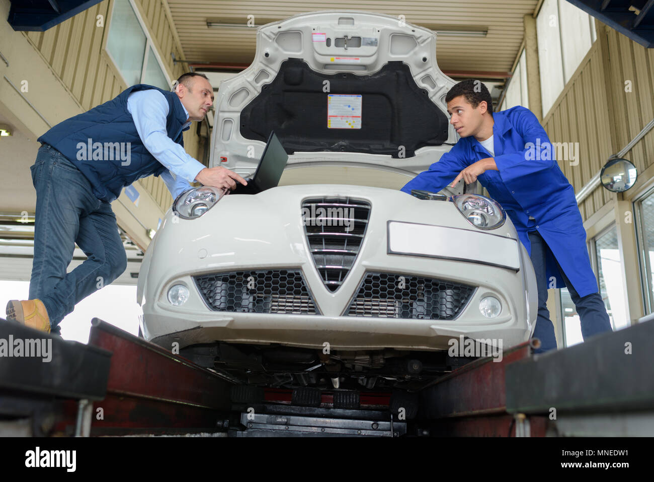 mechanic and boss fixing an engine Stock Photo - Alamy
