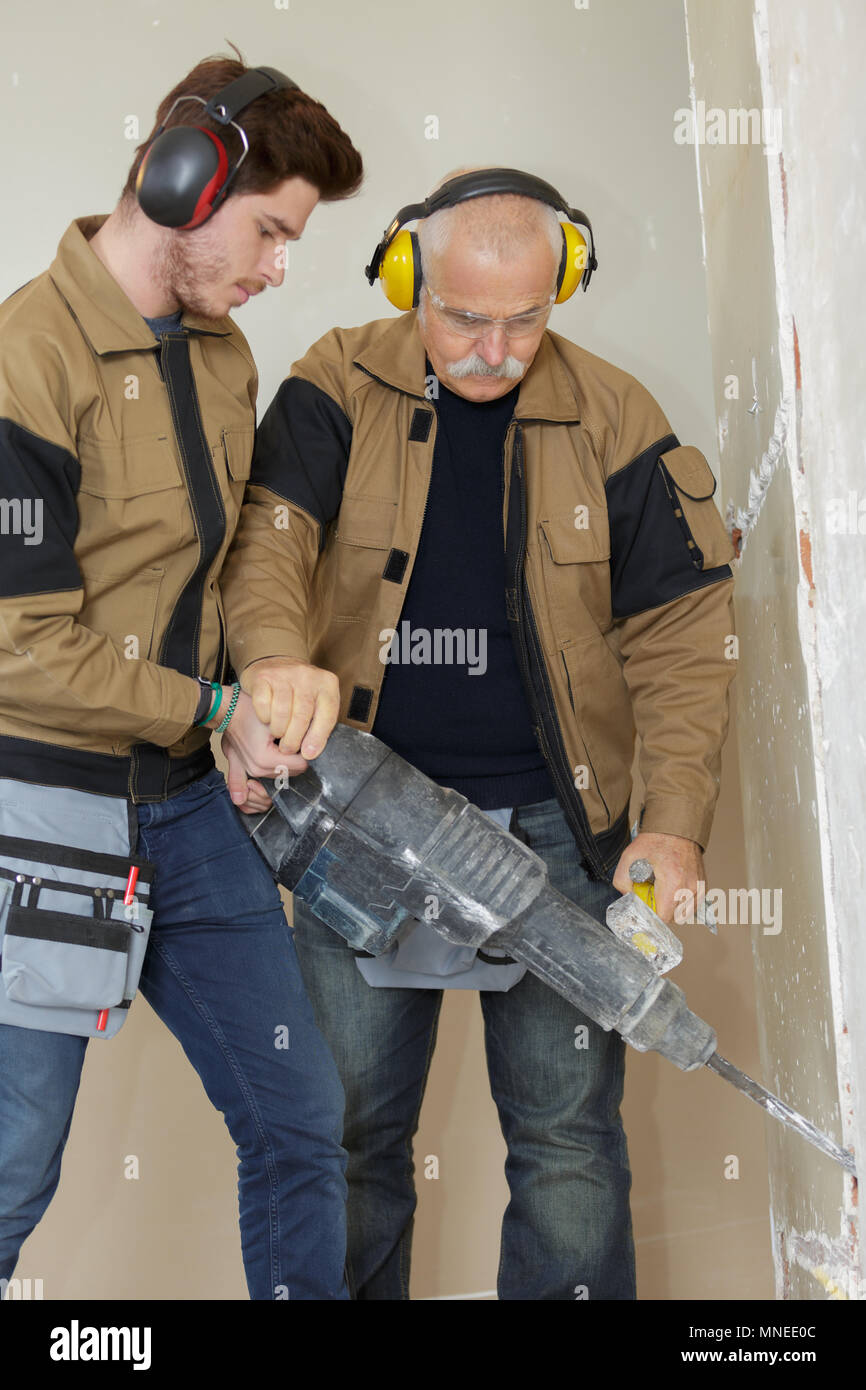 Workmen using hammer drill Stock Photo - Alamy