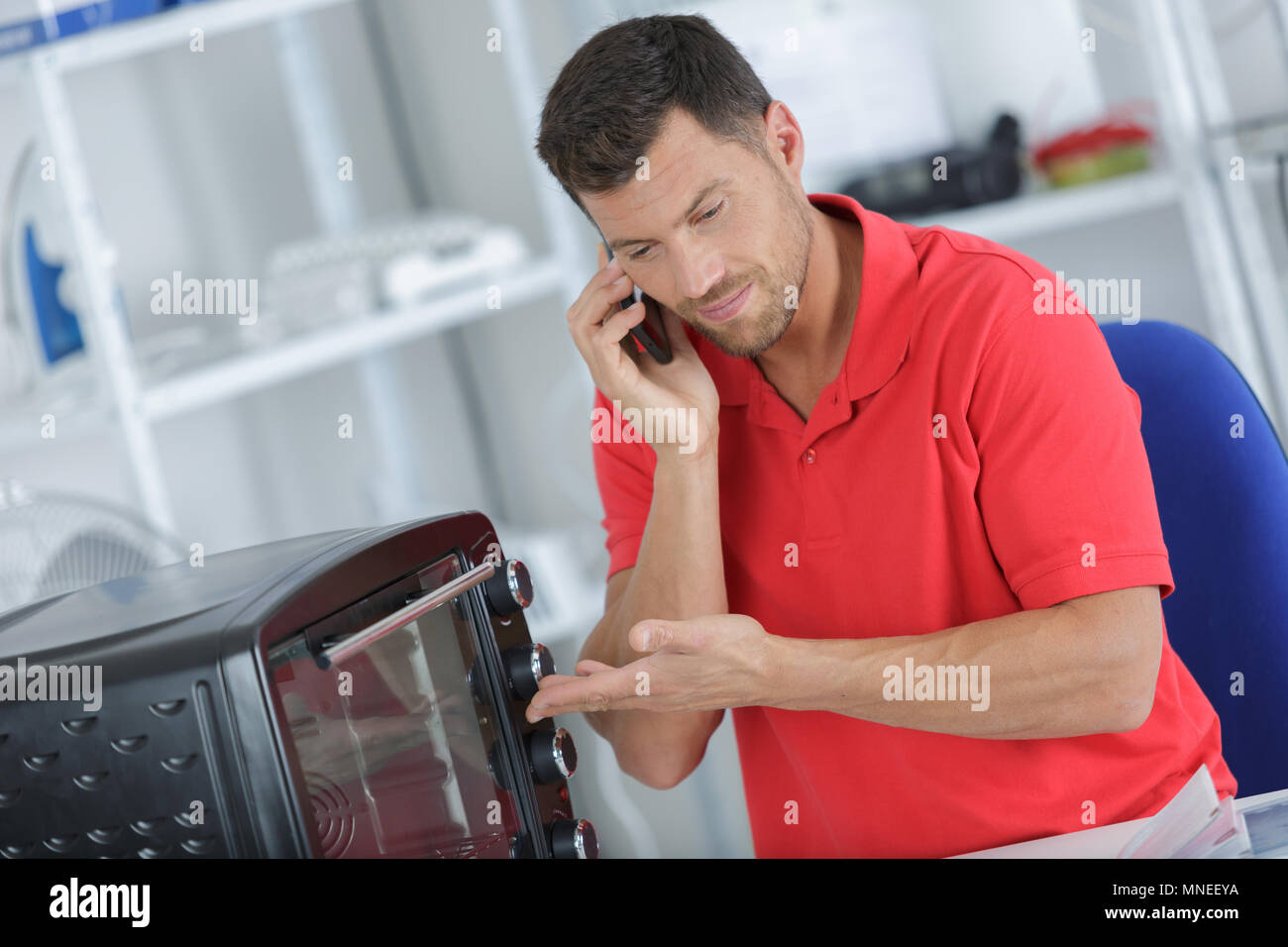 Man calling for support to repair electrical appliance Stock Photo - Alamy