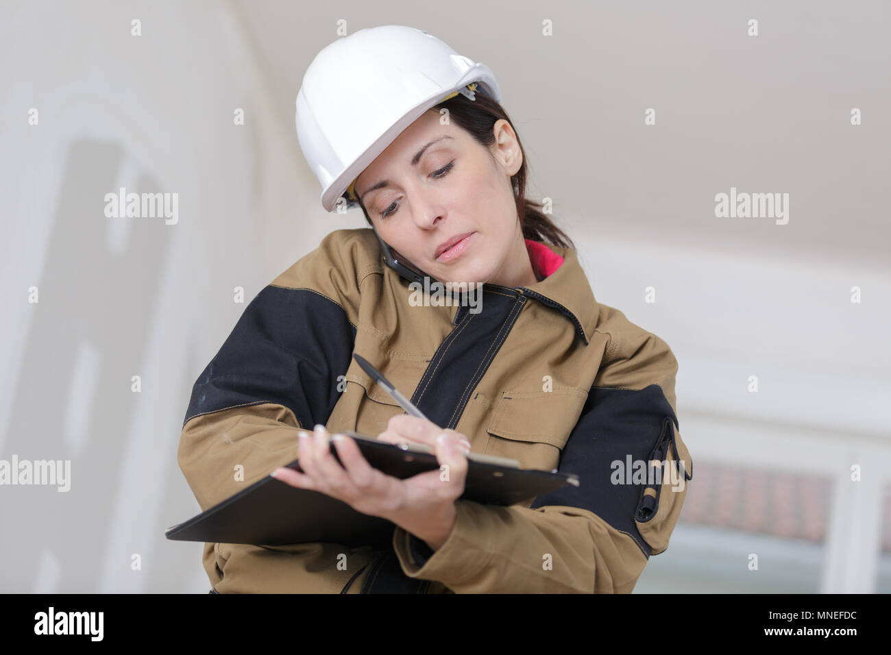 female construction manager doing her survey Stock Photo - Alamy