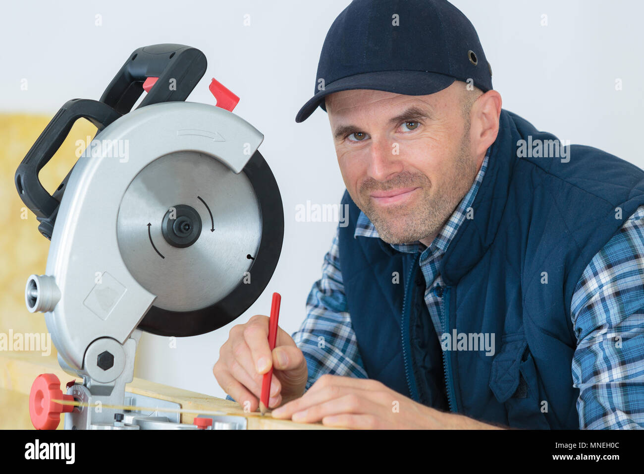 carpenter posing next to a drop saw Stock Photo - Alamy