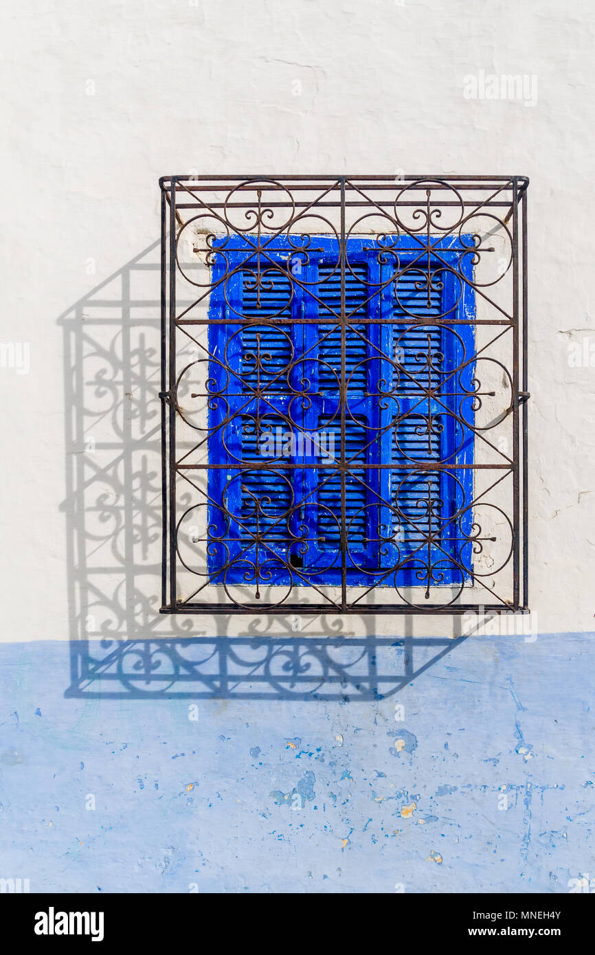 Blue window with styled iron grid Stock Photo - Alamy