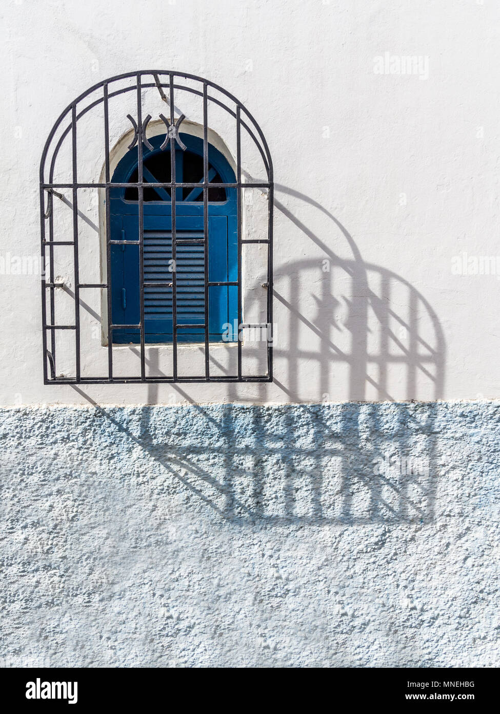 Blue window with styled iron grid Stock Photo - Alamy