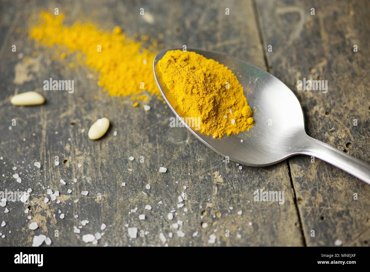 Turmeric powder on a spoon Stock Photo - Alamy