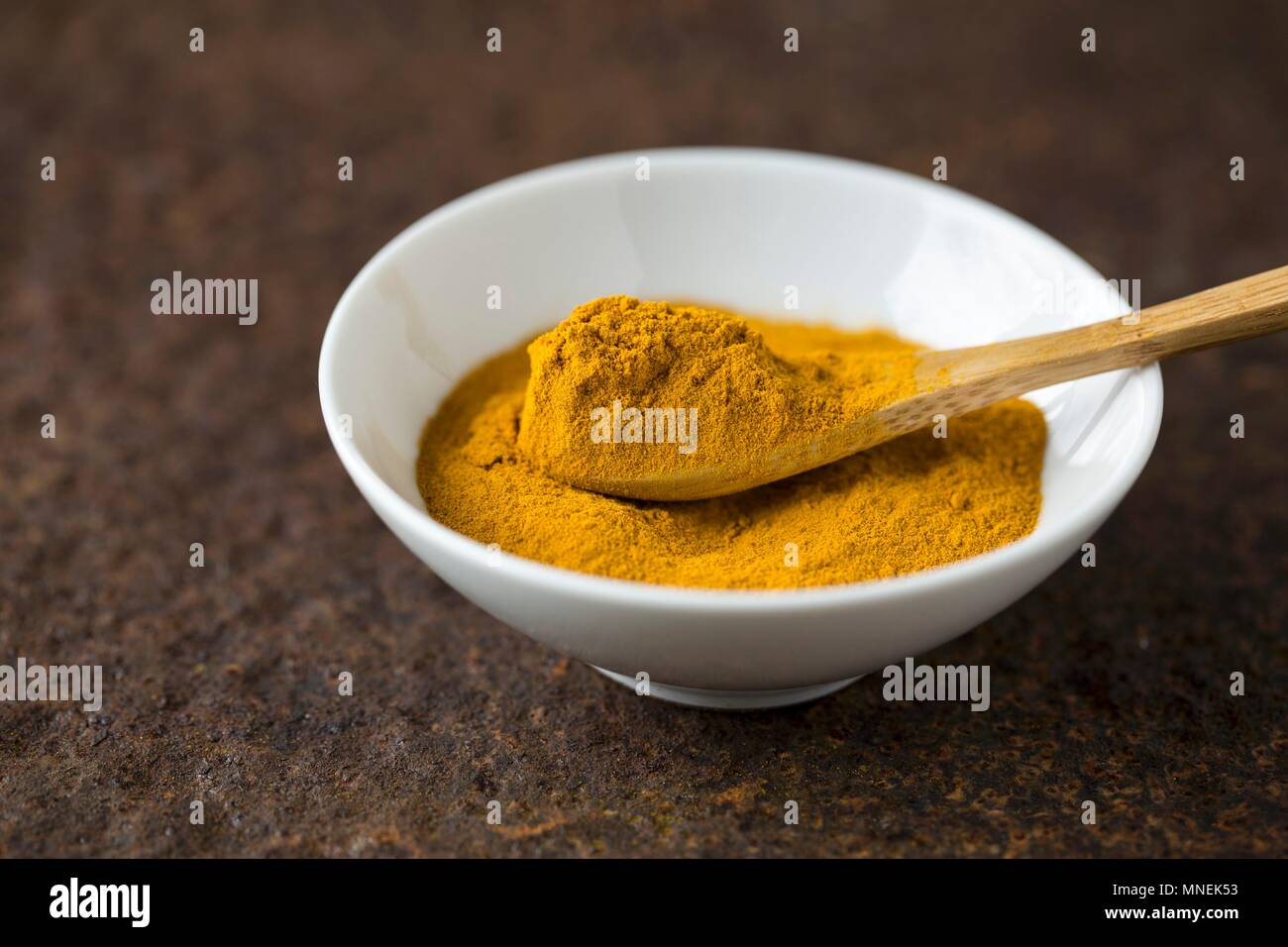 Ground turmeric in a small bowl Stock Photo - Alamy