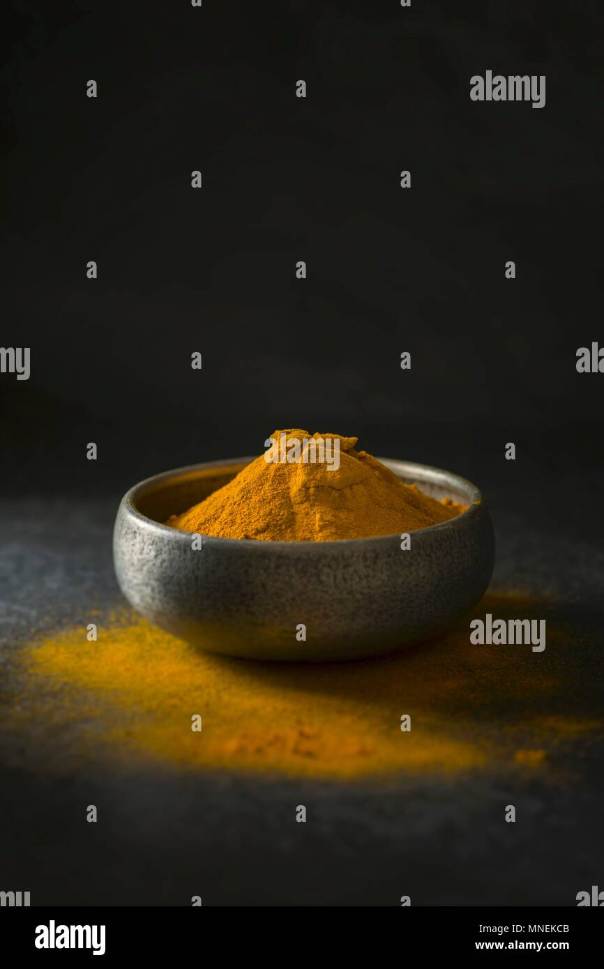 Ground turmeric in a dish Stock Photo - Alamy