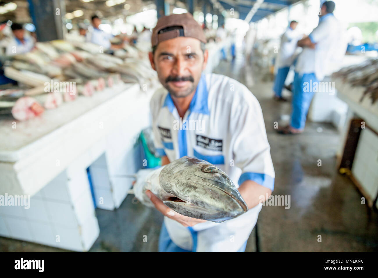 Fish seller holding tuna fish Stock Photo - Alamy