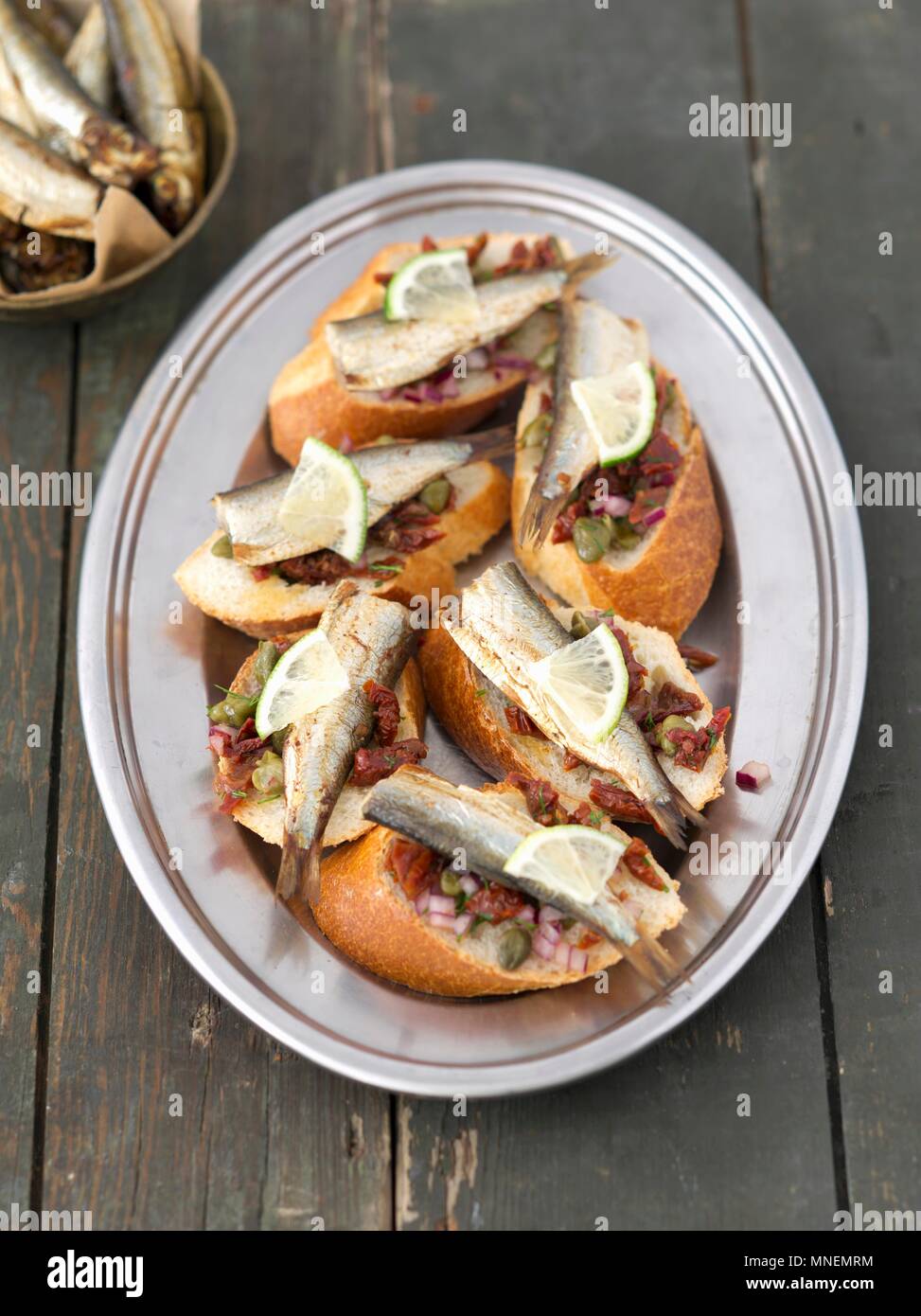 Baguette with smoked sprats and tomato salsa Stock Photo - Alamy