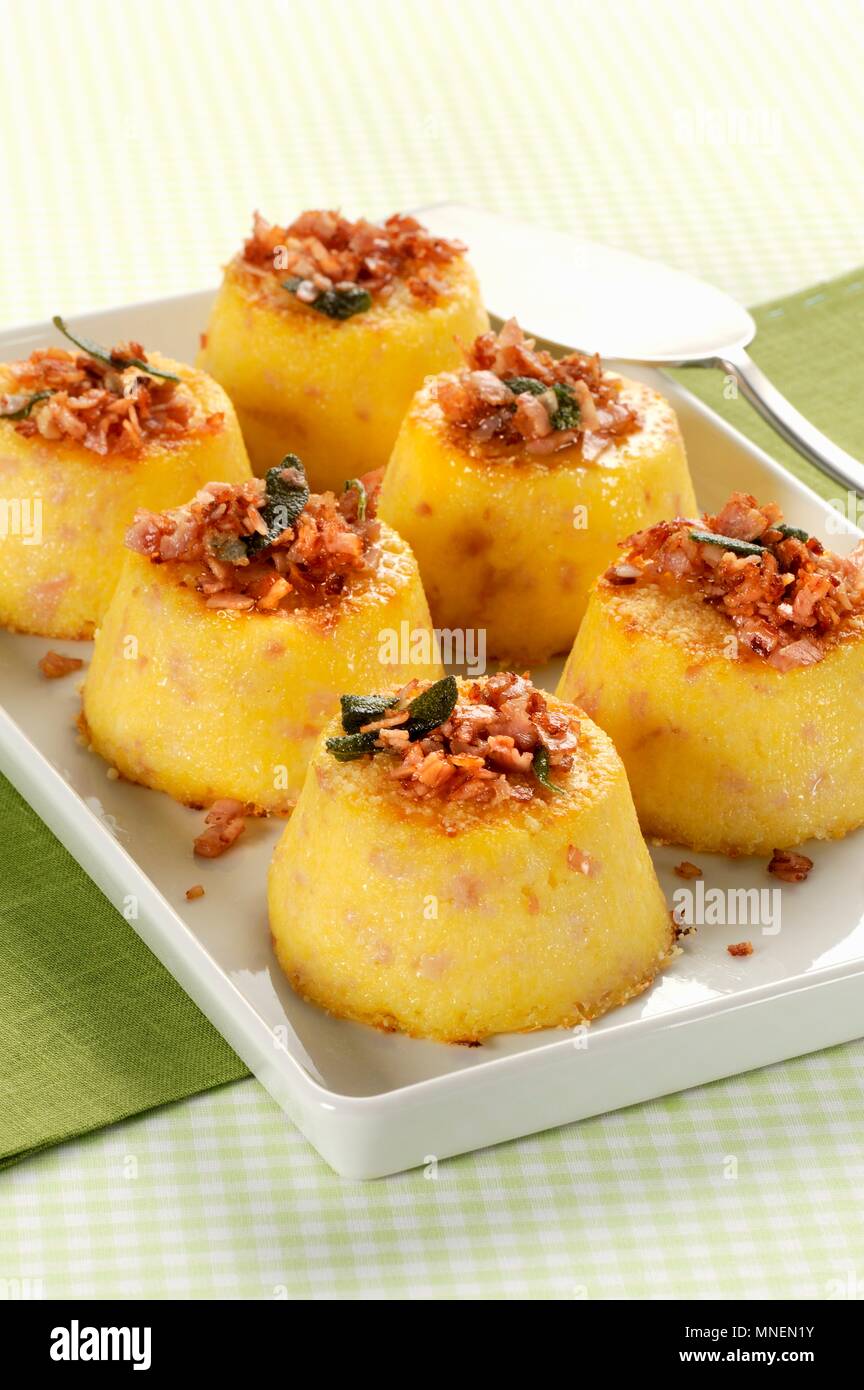 Spicy polenta pudding with crispy sage bacon Stock Photo - Alamy