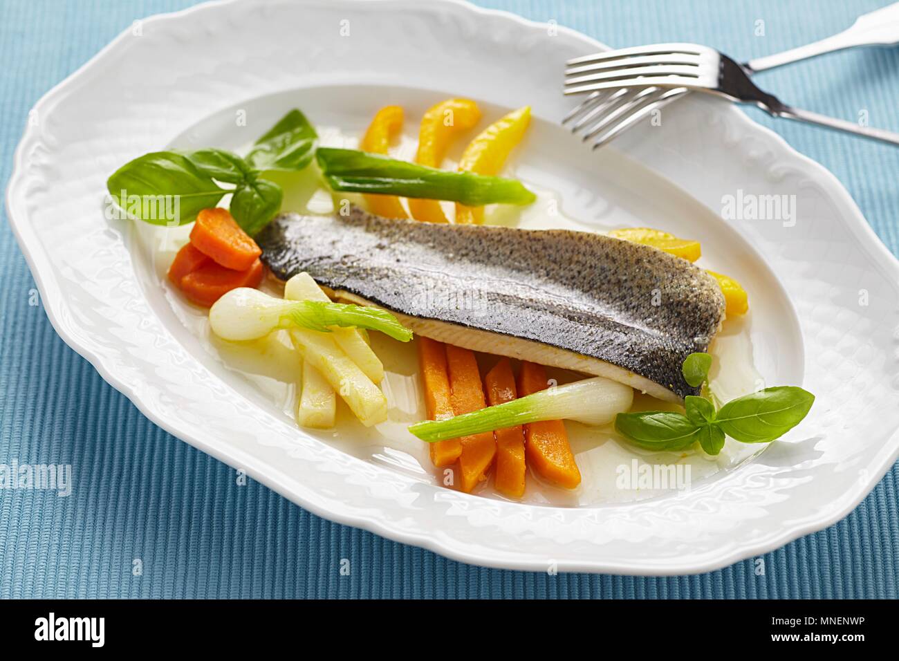 Poached trout with glazed vegetables Stock Photo - Alamy