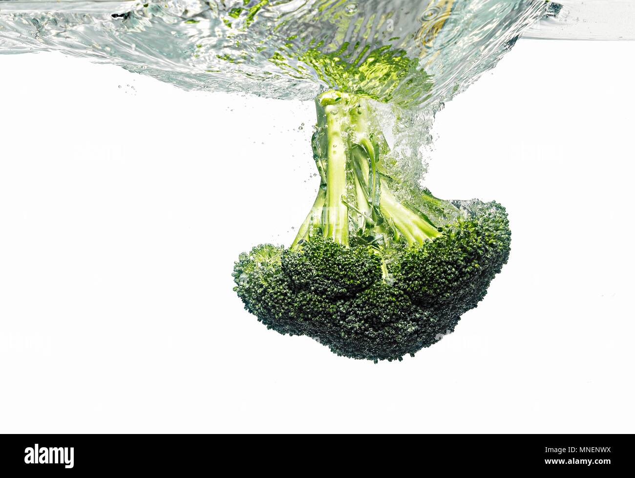 Broccoli falling into water Stock Photo - Alamy