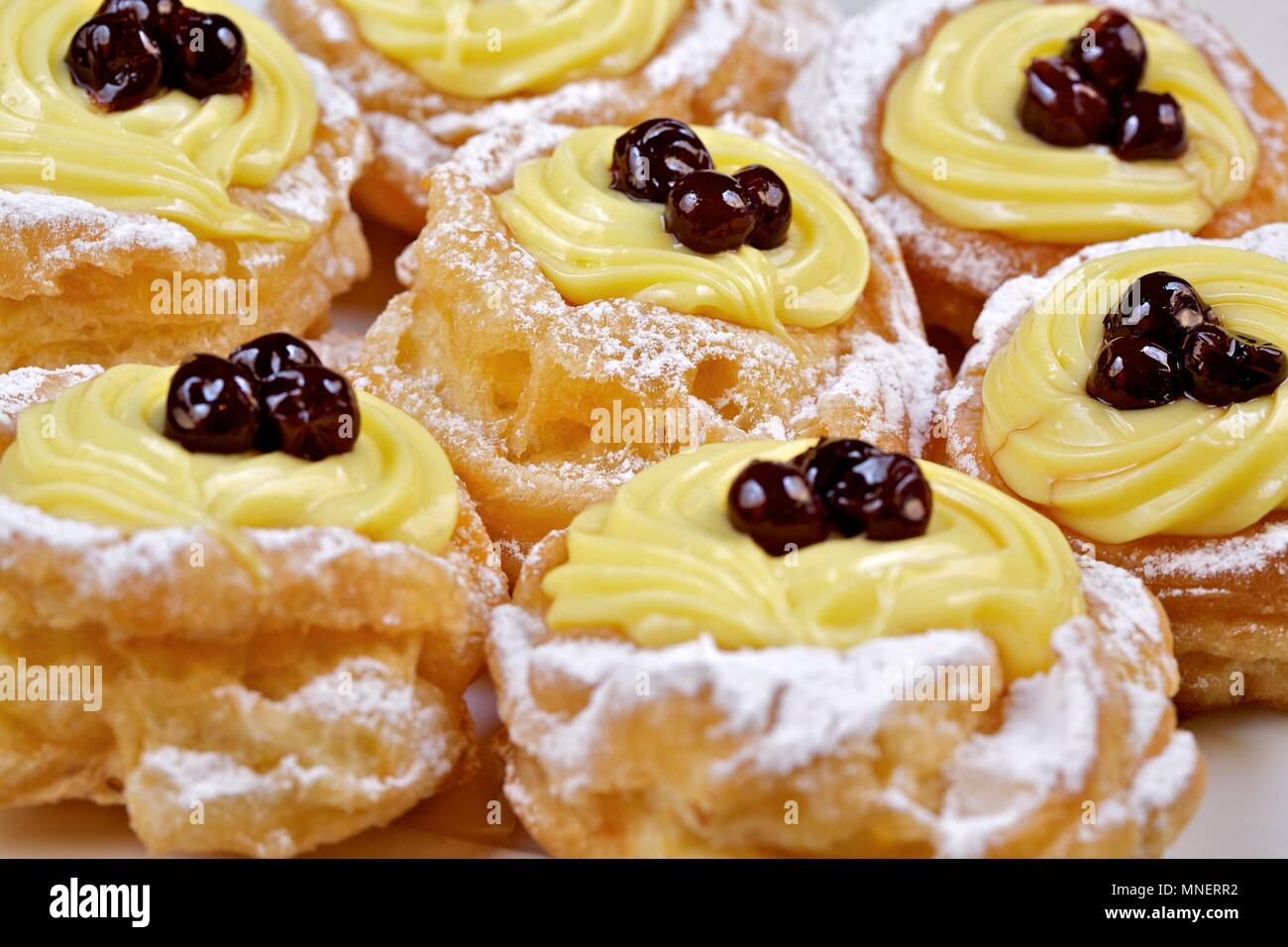 Zeppole di San Giuseppe (choux pastries filled with cream and amarena ...