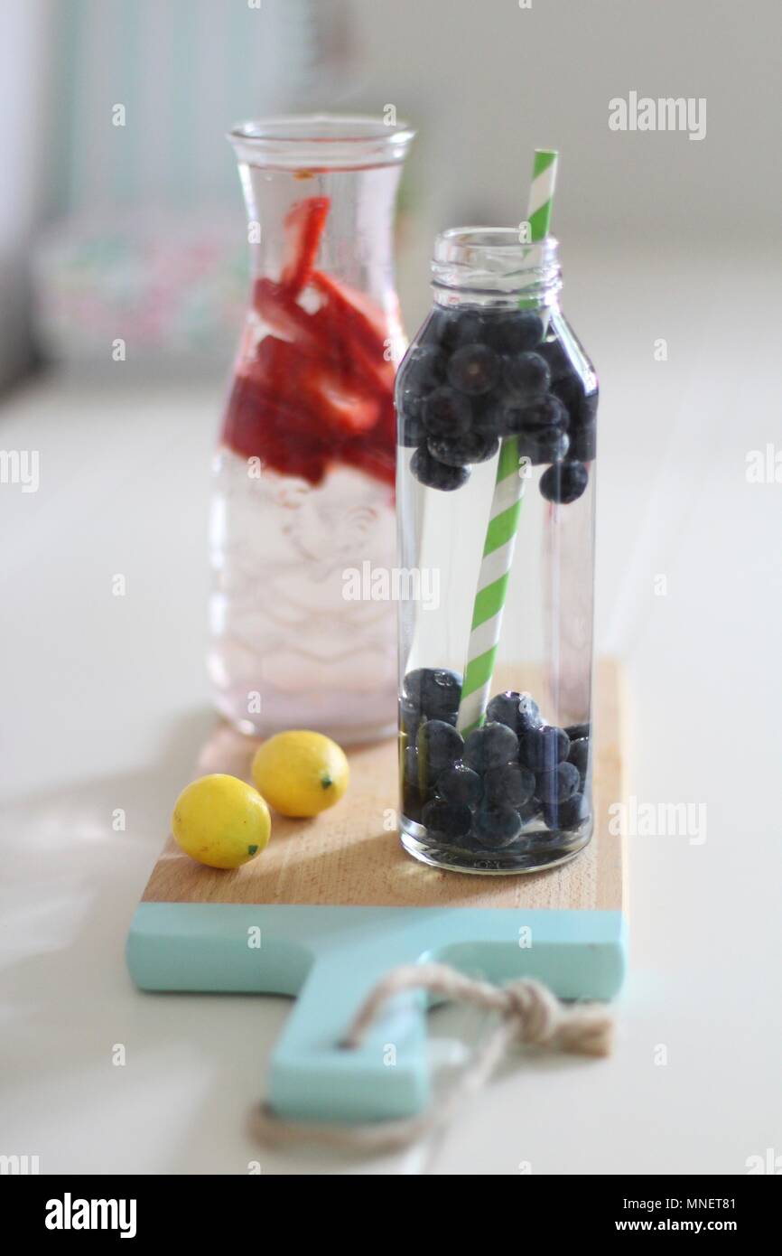 Infused water: water flavoured with fresh berries Stock Photo - Alamy