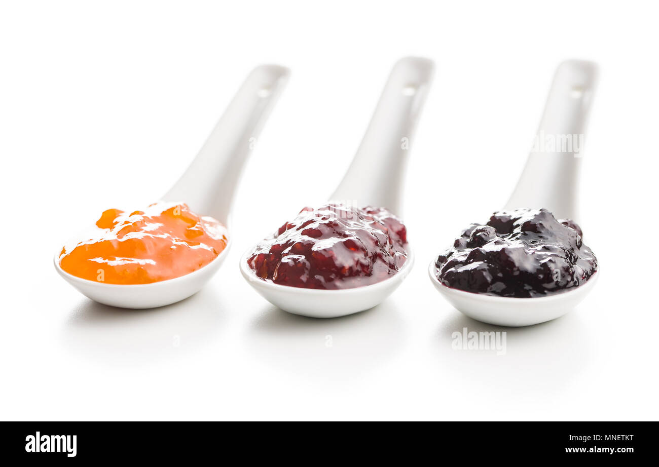 Tasty fruity jam in ceramic spoon isolated on white background Stock ...
