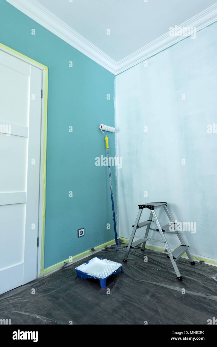 Painting tools on wall background Stock Photo - Alamy