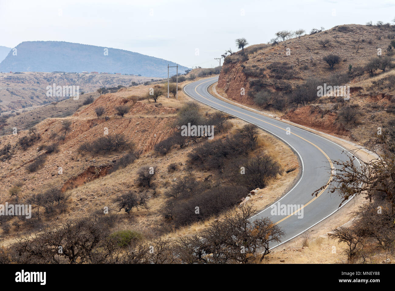 A winding mountain road running through the arid terrain of the Middle ...