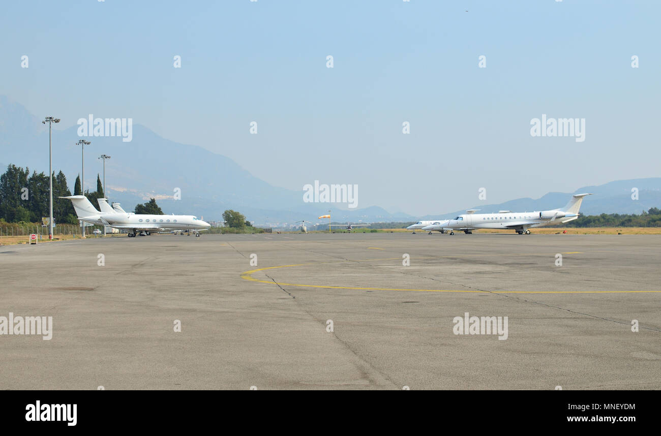 Two airplanes parked on an empty runway with a landscape in a ...