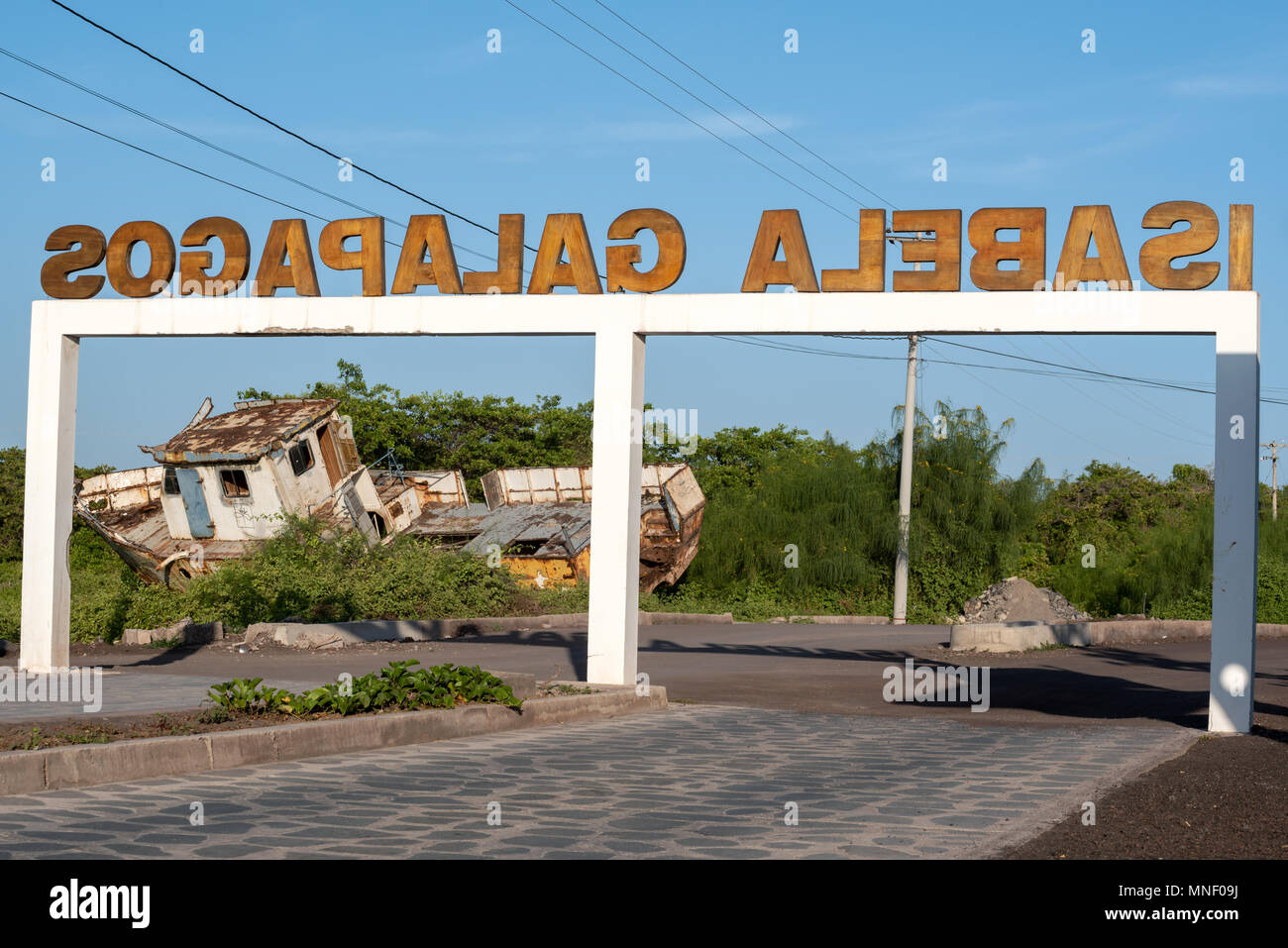 Abandoned boat and Isabela Galapagos sign over the road to Isabela ...