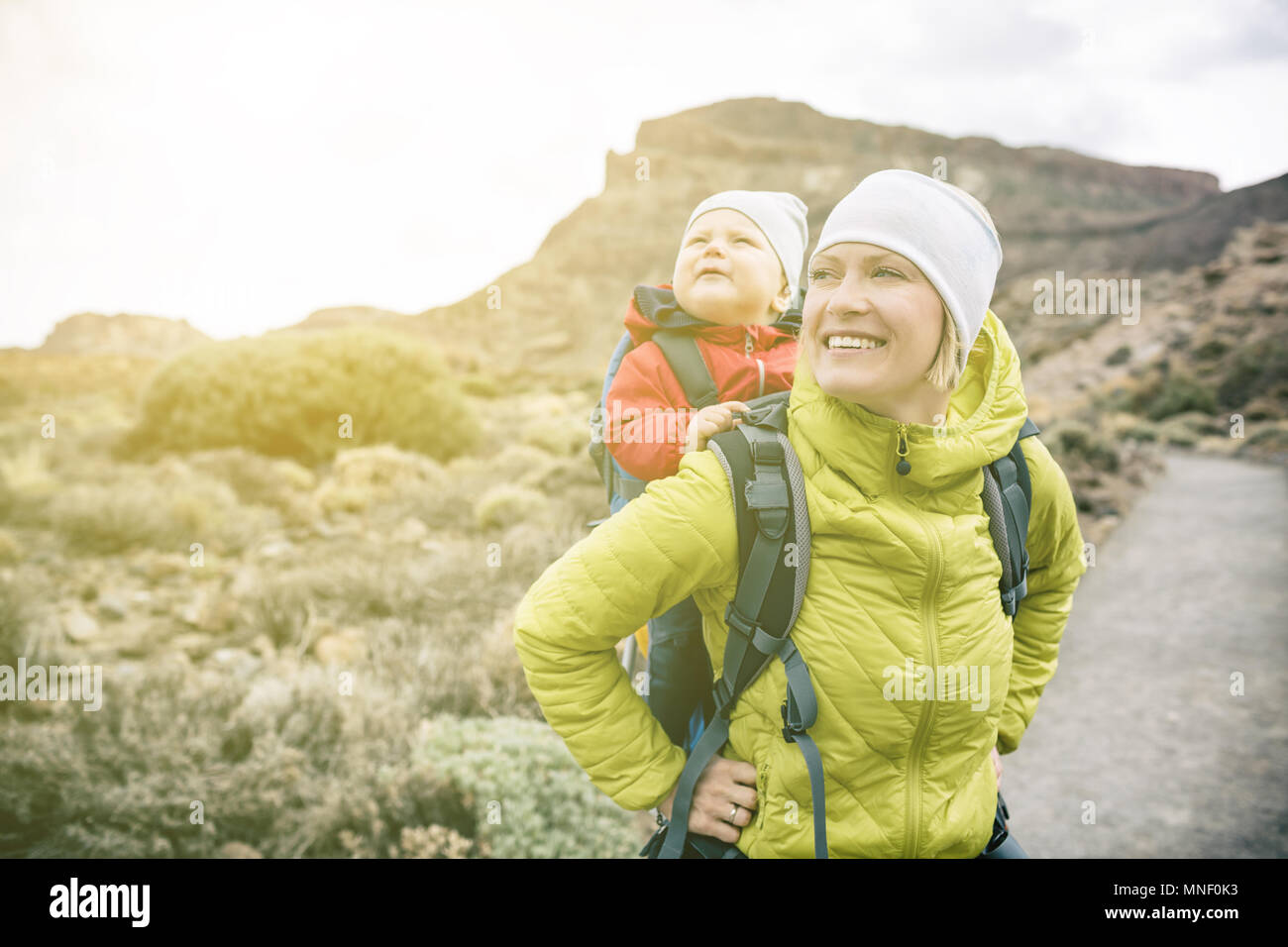 Super mom with baby boy travelling in backpack. Mother on hiking ...