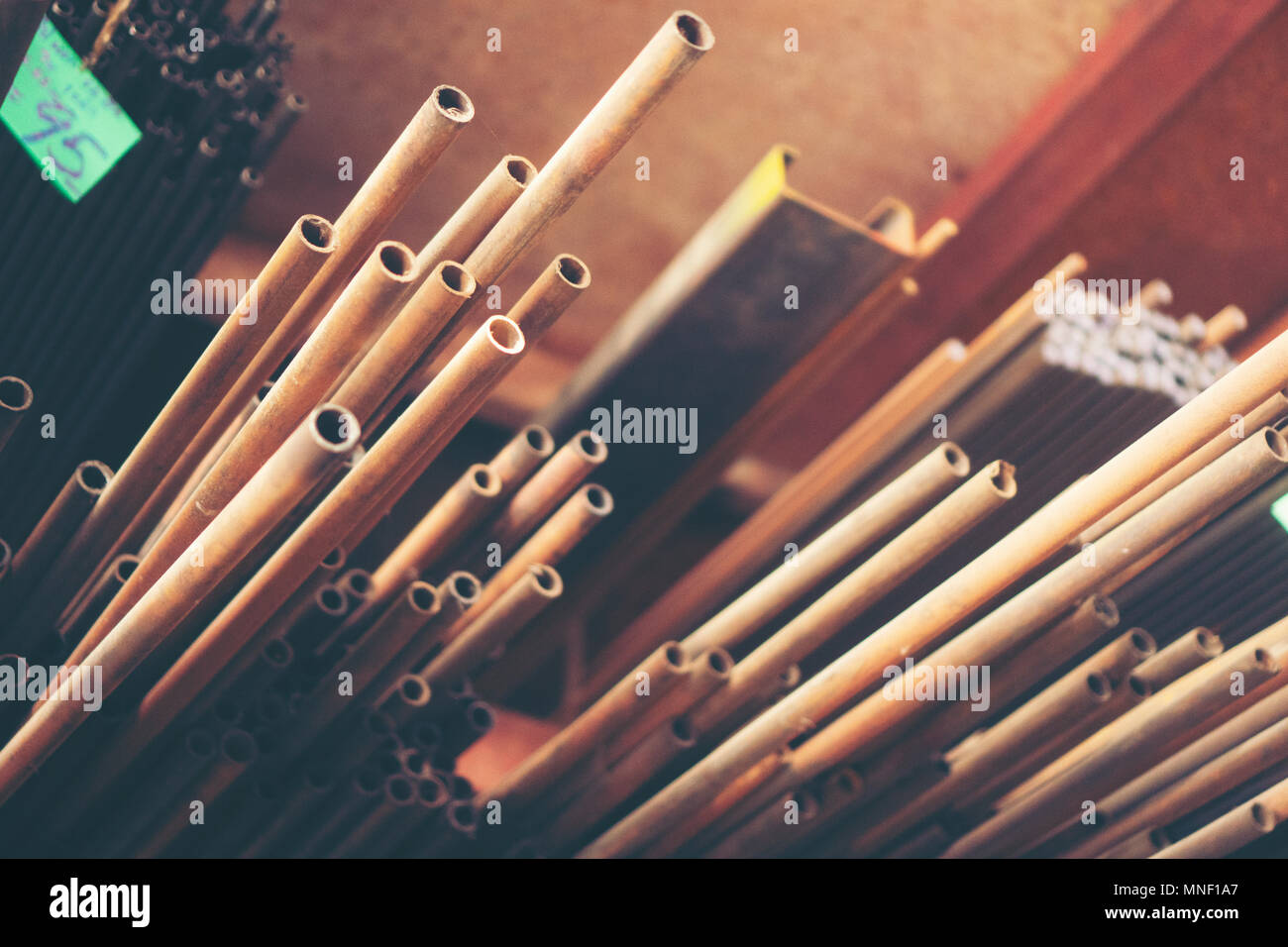 Stack of steel pipes in metal factory shop Stock Photo - Alamy