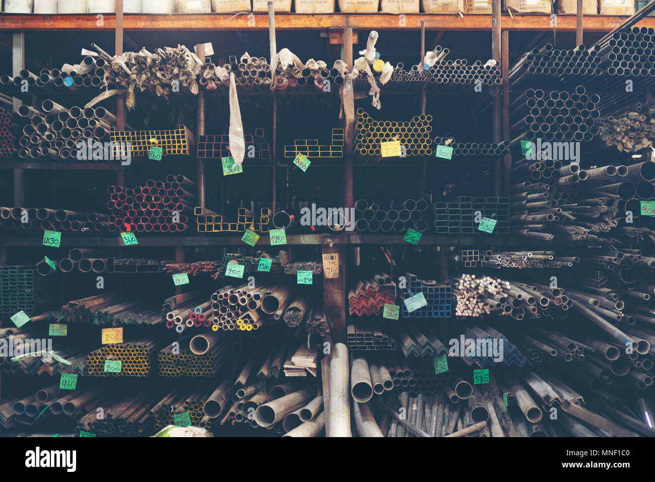 Stack of steel pipes in metal factory shop Stock Photo - Alamy