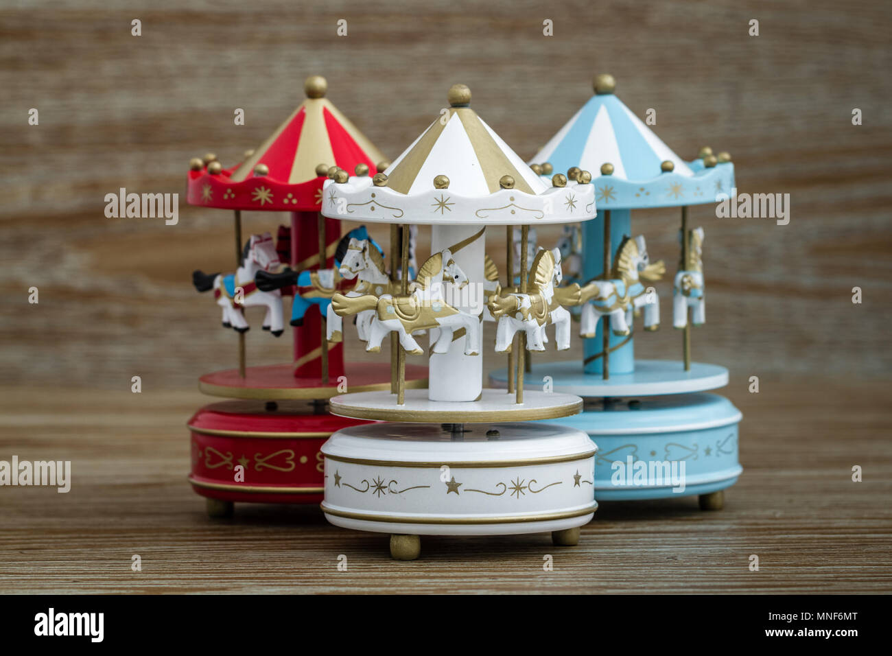 Carousel music boxes on brown wooden background Stock Photo - Alamy