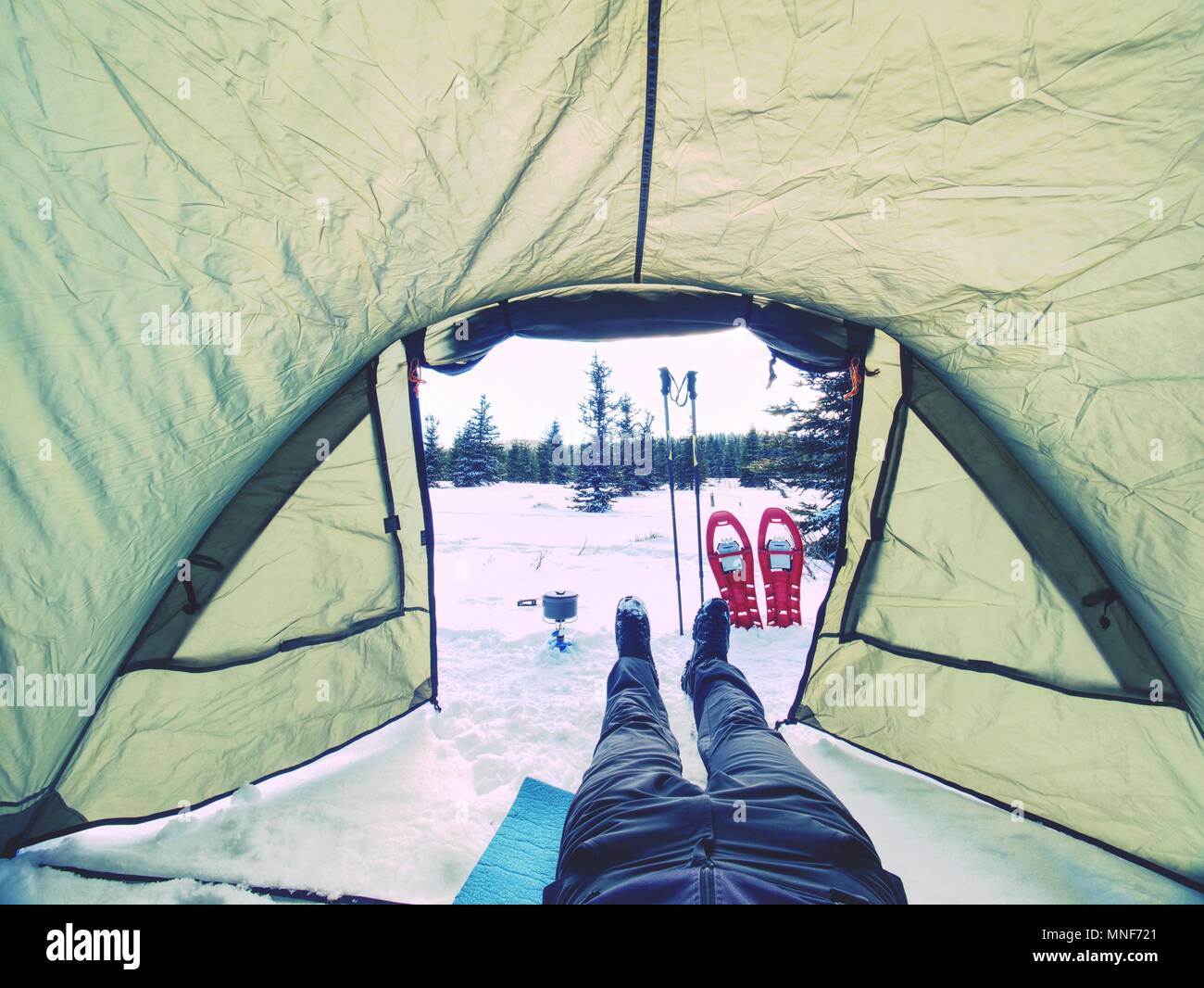 Camping in winter forest, cooking in front of tent in snow. Making a ...