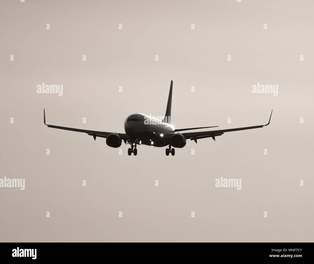 Jumbo jet high contrast landing Stock Photo - Alamy