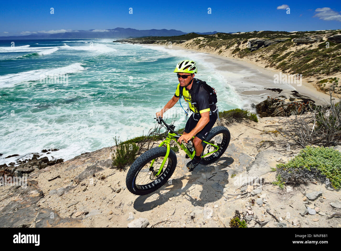 Mountainbiker with Fatbike on cliff, bike tour at Die Plaat Beach ...