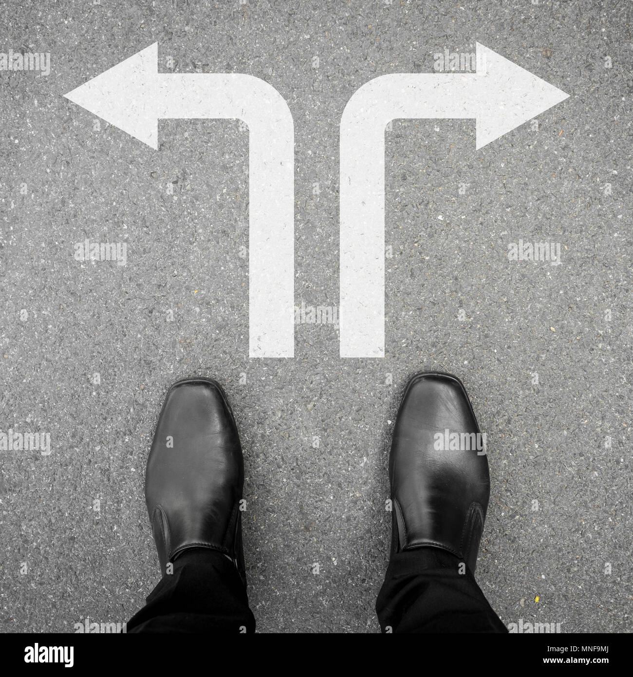 Businessman In Black Leather Shoes Standing At The Crossroad Making