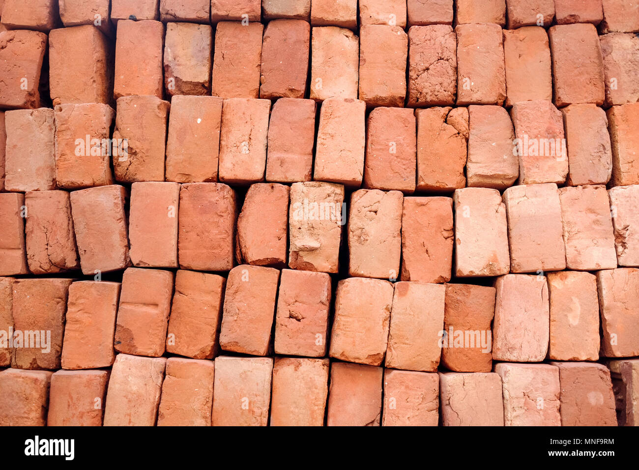 Stacking red bricks on construction site prepared for making building ...