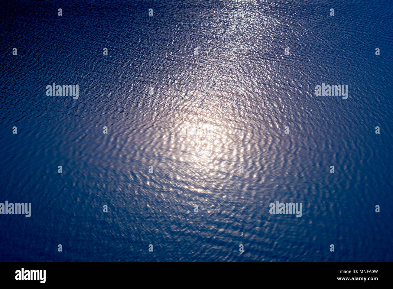 Abstract blur sun reflection on the water in the lake for background ...