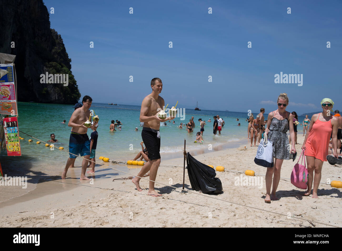 Western tourist enjoy time in the sun on Thailand's Railey beach Stock ...