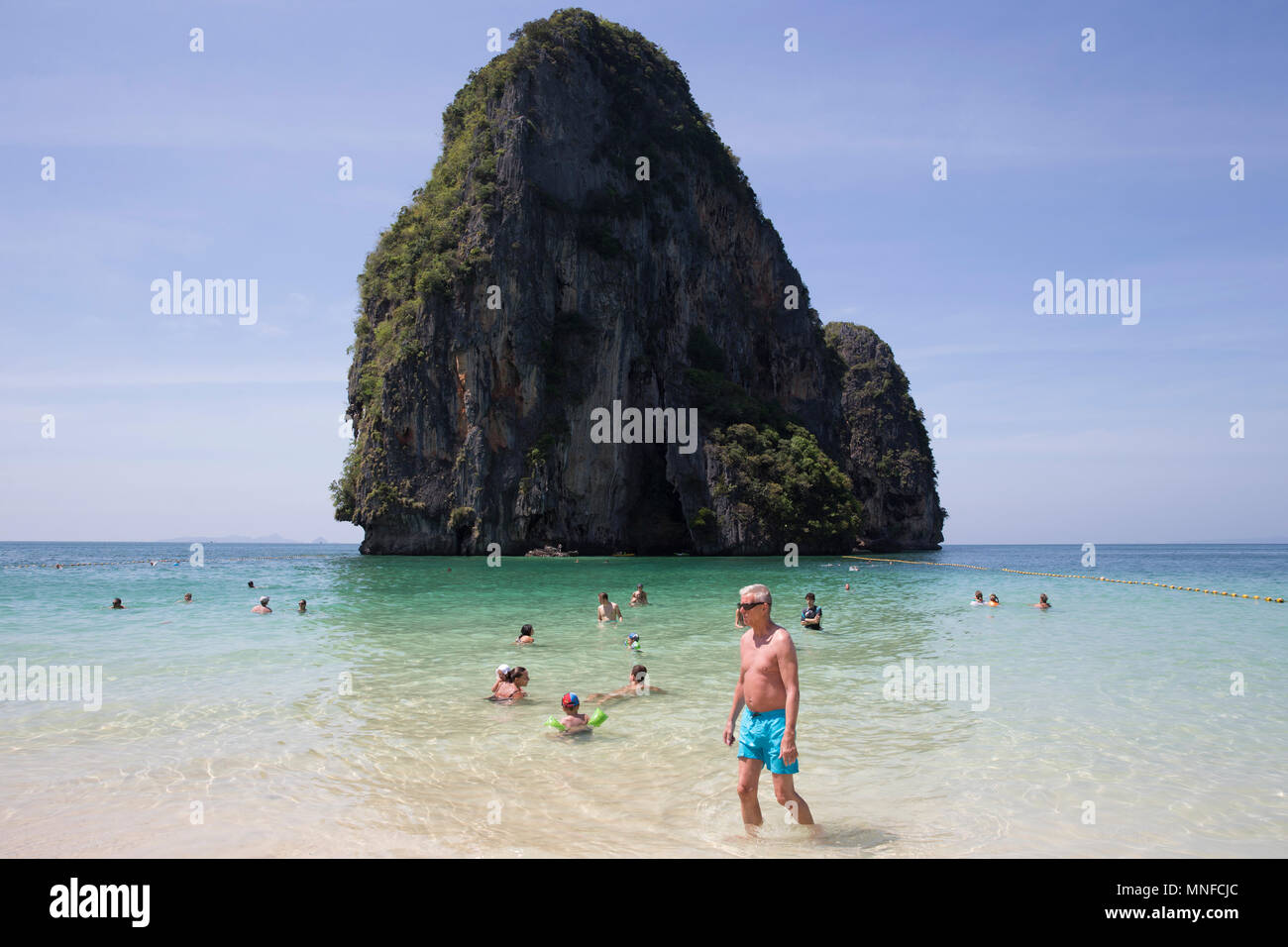 Western tourist enjoy time in the sun on Thailand's Railey beach Stock ...