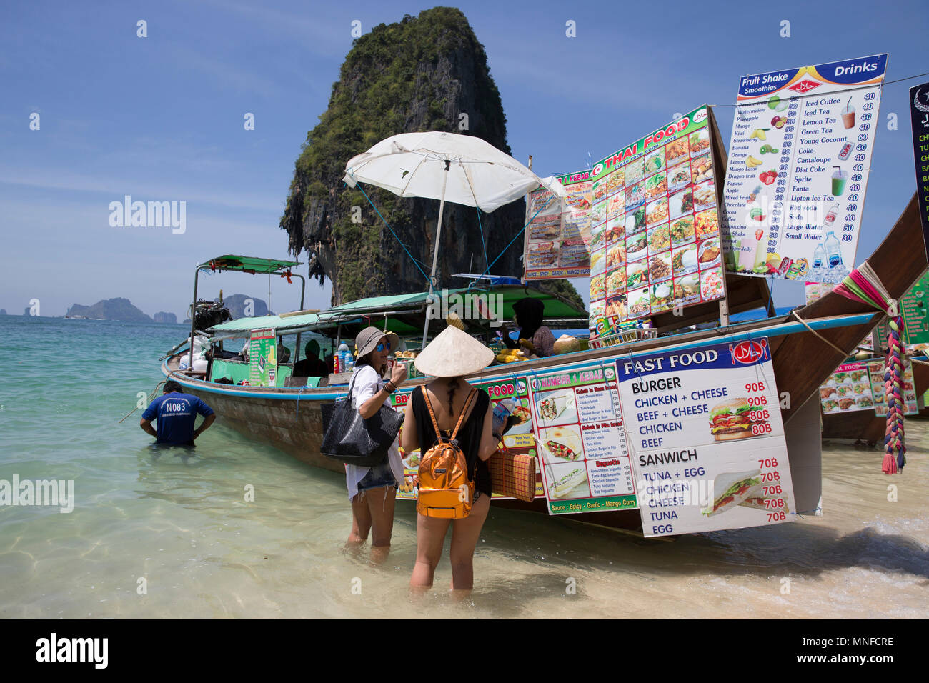 Western tourist enjoy time in the sun on Thailand's Railey beach Stock ...